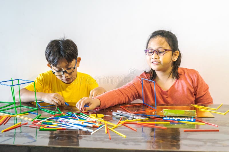 Young Children are Constructing Colorful Plastic Sticks with Glue Gun ...