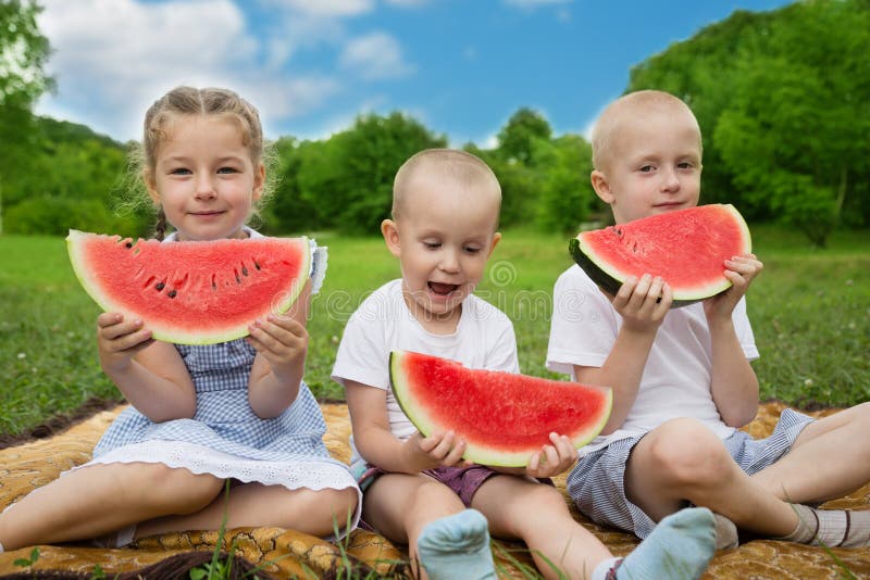 Young Children Eating Watermelon Stock Photo - Image of grass, kids ...