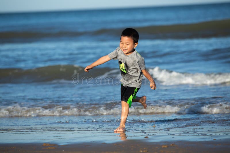 A Young Chinese Boy Playing and Running on the Beach Stock Image ...
