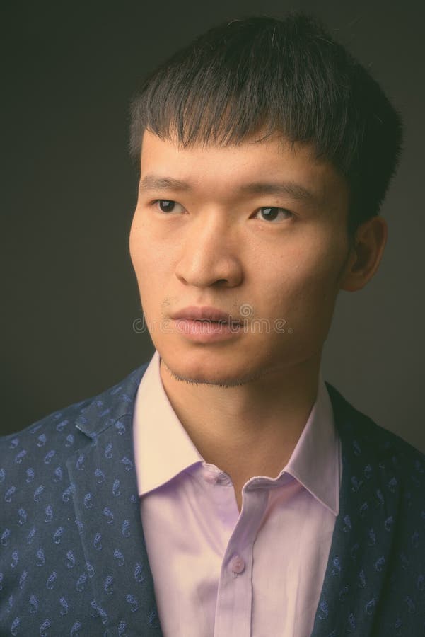 Studio Shot of Young Chinese Man Against Gray Background Stock Image ...
