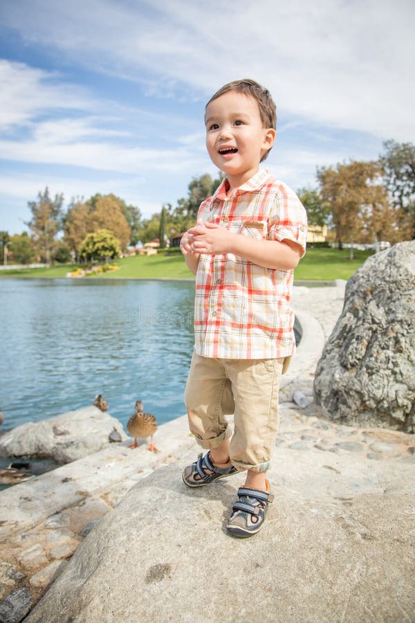 Young Chinese and Caucasian Boy Having Fun at the Park and Duck Pond ...