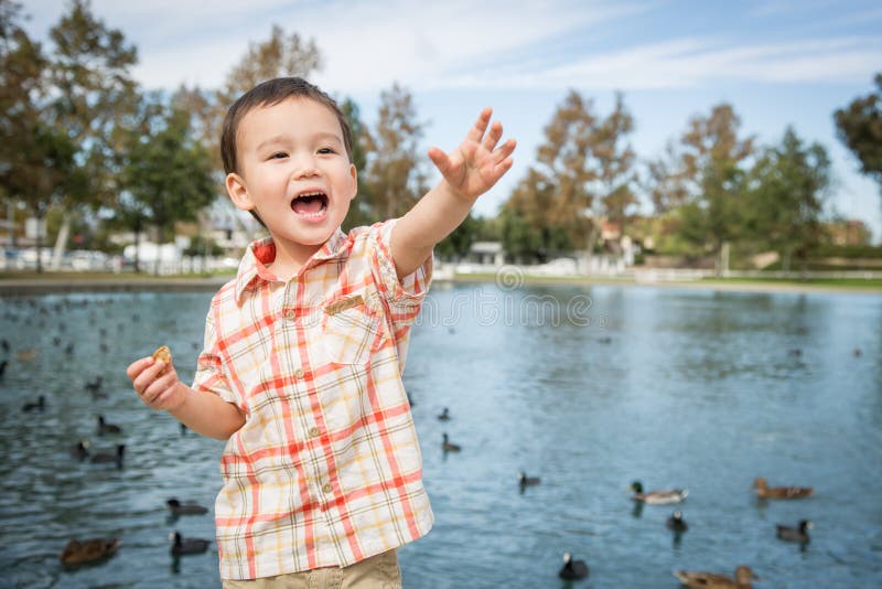 Young Chinese and Caucasian Boy Having Fun at the Park and Duck Pond ...