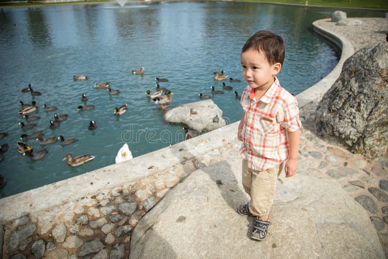 Young Chinese and Caucasian Boy Having Fun at the Park and Duck Pond ...
