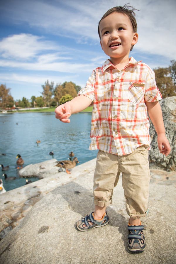 Young Chinese and Caucasian Boy Having Fun at the Park and Duck Pond ...