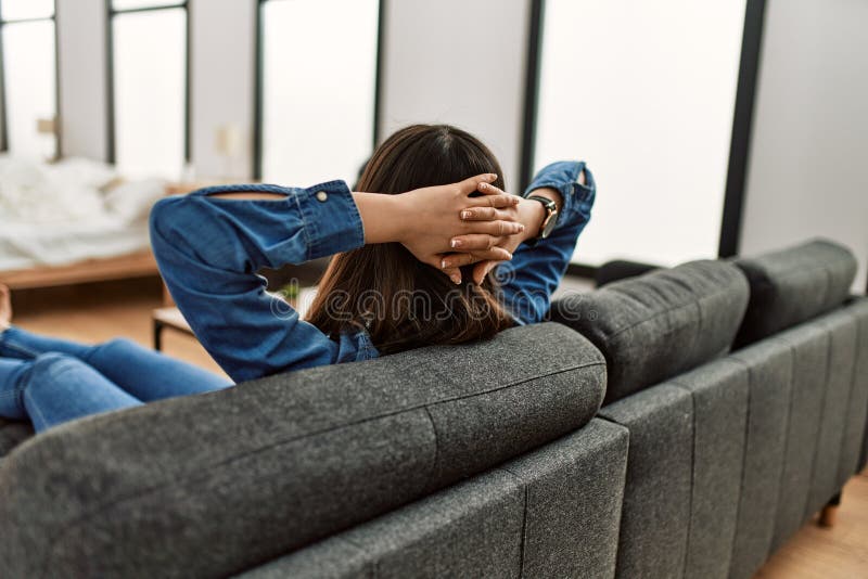 Young Chinese Girl on Back View Lying on the Sofa with Hands on Head at ...