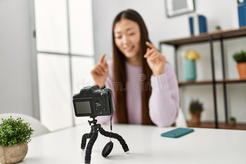 Young Chinese Girl Having Video Call Using Camera Sitting on the Table ...