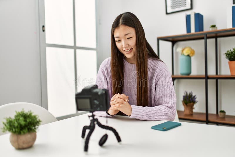 Young Chinese Girl Having Video Call Using Camera Sitting on the Table ...