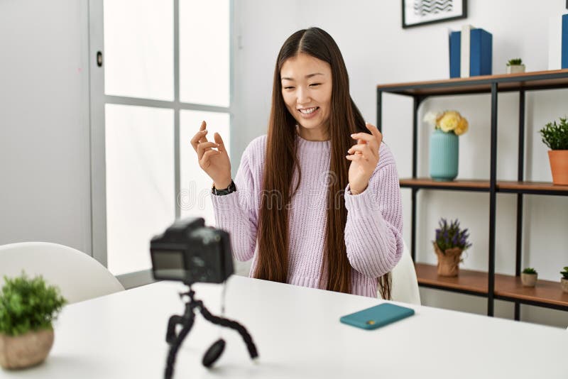 Young Chinese Girl Having Video Call Using Camera Sitting on the Table ...