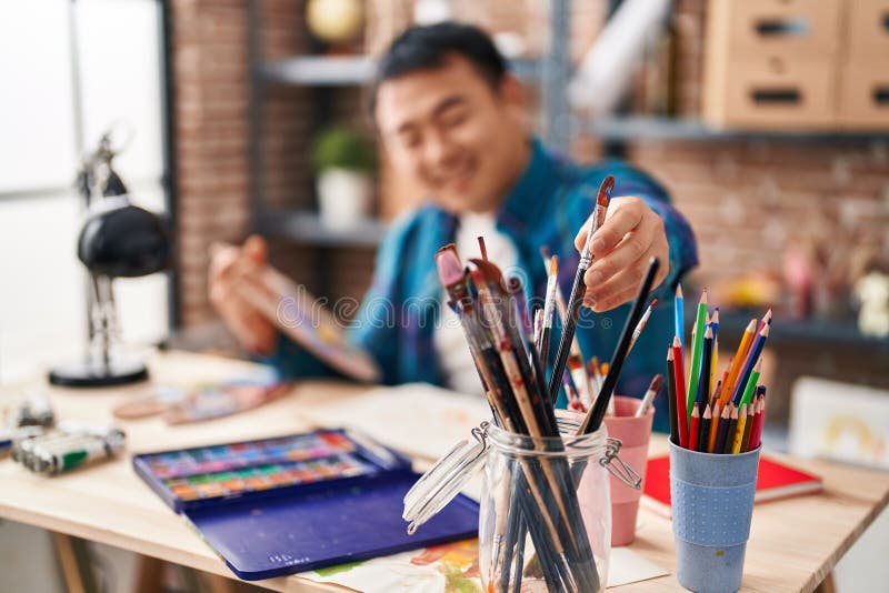 Young Chinese Man Artist Drawing on Notebook at Art Studio Stock Photo ...