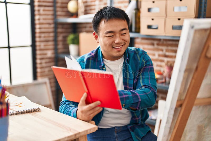 Young Chinese Man Artist Reading Book at Art Studio Stock Image - Image ...