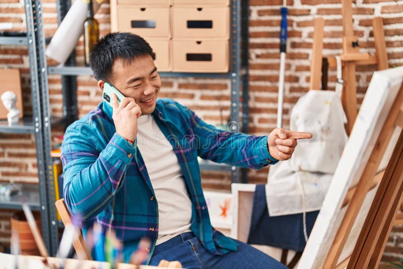 Young Chinese Man Artist Talking on the Smartphone at Art Studio Stock ...