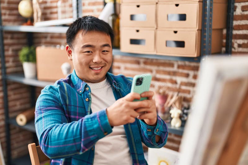 Young Chinese Man Artist Using Smartphone at Art Studio Stock Photo ...