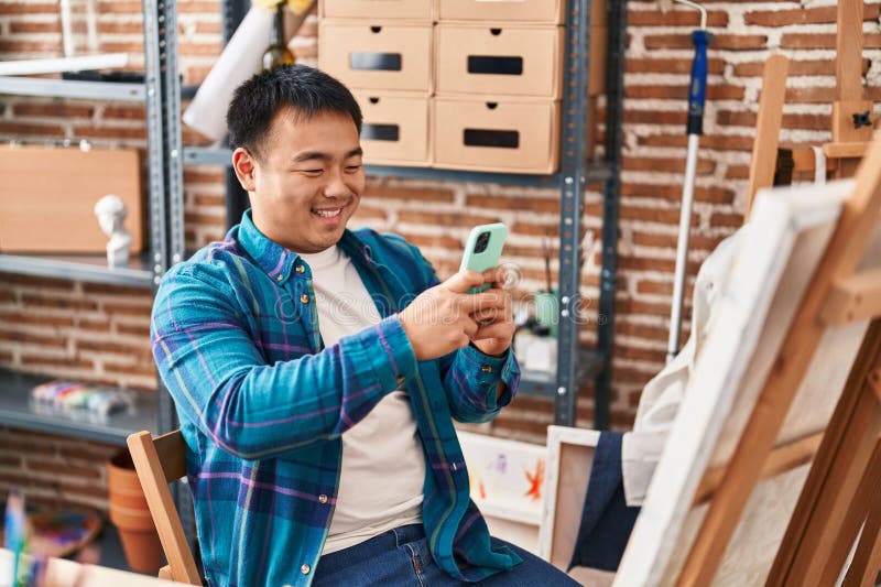 Young Chinese Man Artist Using Smartphone at Art Studio Stock Image ...