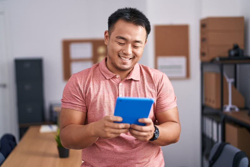 Young Chinese Man Business Worker Smiling Confident Using Touchpad at ...