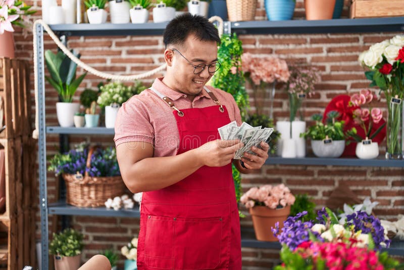 Young Chinese Man Florist Smiling Confident Counting Dollars at Florist ...