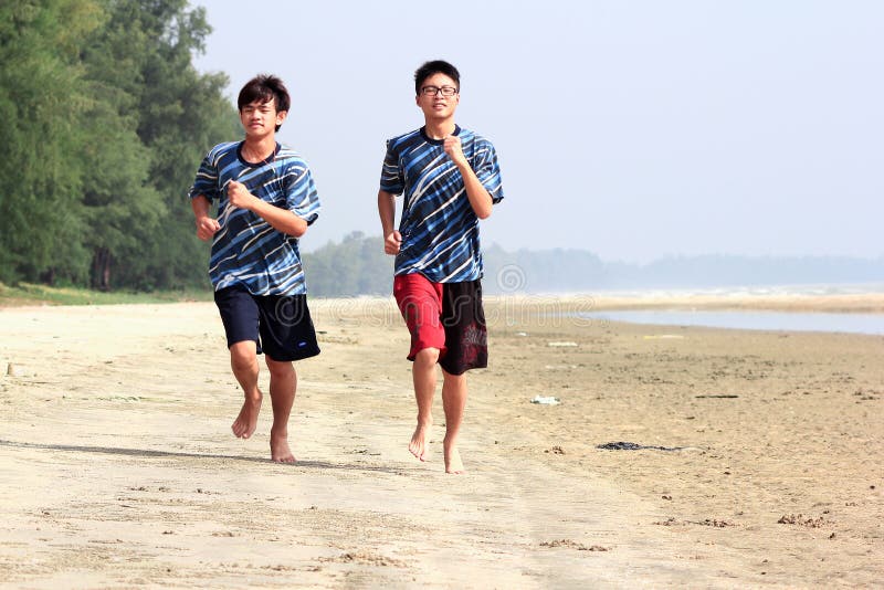 Young Chinese Man Jogging on the Beach Stock Photo - Image of male ...