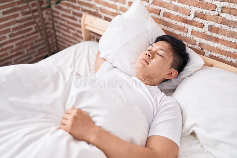 Young Chinese Man Lying on Bed Sleeping at Bedroom Stock Photo - Image ...