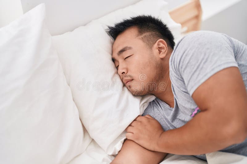 Young Chinese Man Lying on Bed Sleeping at Bedroom Stock Photo - Image ...