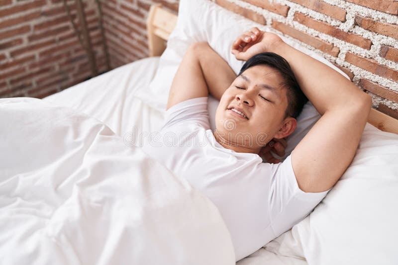 Young Chinese Man Lying on Bed Sleeping at Bedroom Stock Image - Image ...