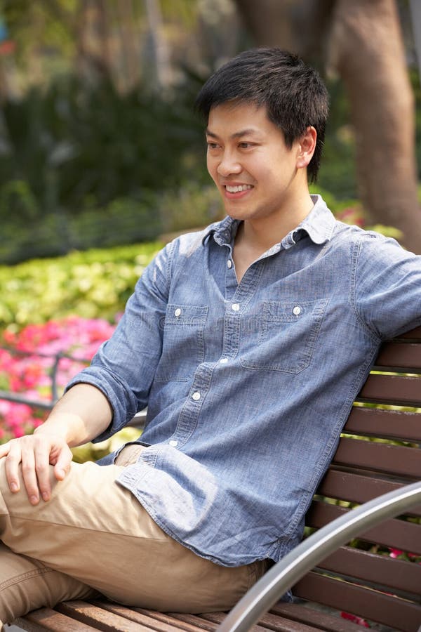 Young Chinese Man Relaxing on Park Bench Stock Image - Image of asia ...