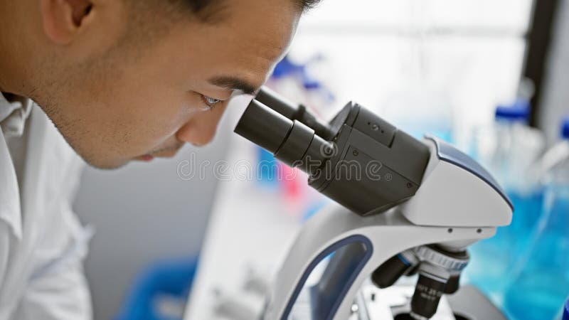 Young Chinese Man Scientist Using Microscope at Laboratory Stock Image ...