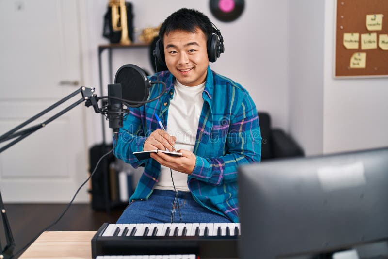 Young Chinese Man Singer Composing Song at Music Studio Stock Photo ...