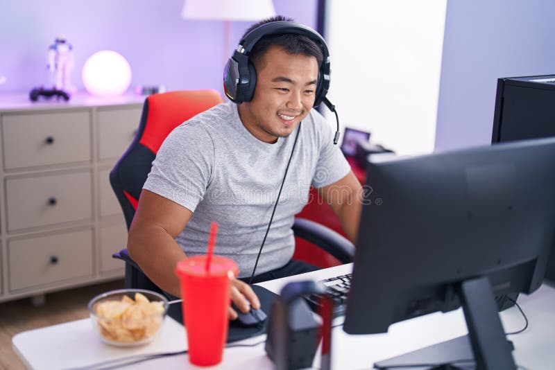 Young Chinese Man Streamer Playing Video Game Using Computer at Gaming ...