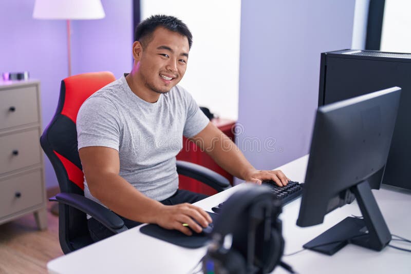 Young Chinese Man Streamer Playing Video Game Using Computer at Gaming ...