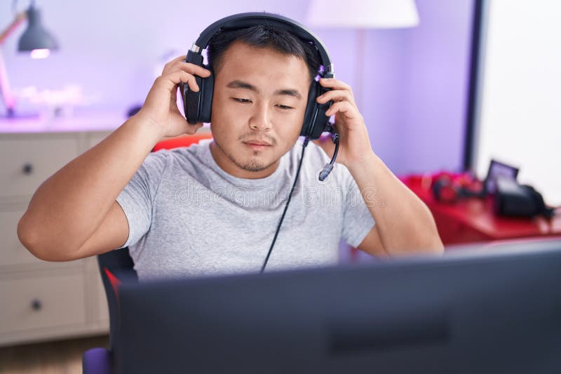 Young Chinese Man Streamer Playing Video Game Using Computer at Gaming ...