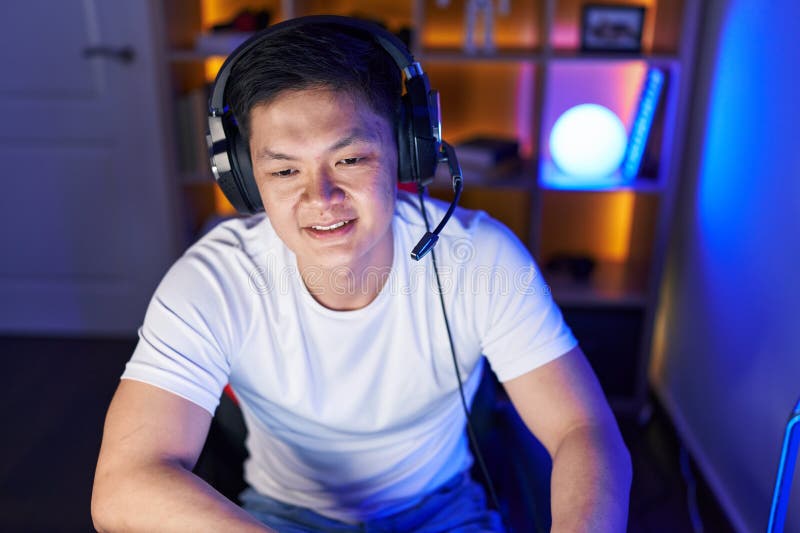 Young Chinese Man Streamer Playing Video Game Using Computer at Gaming ... Young Chinese Man Streamer Playing Video Game Using Computer at Gaming ...