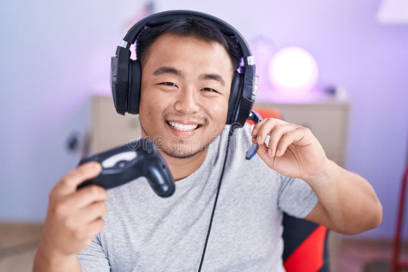 Young Chinese Man Streamer Playing Video Game Using Joystick at Gaming ...