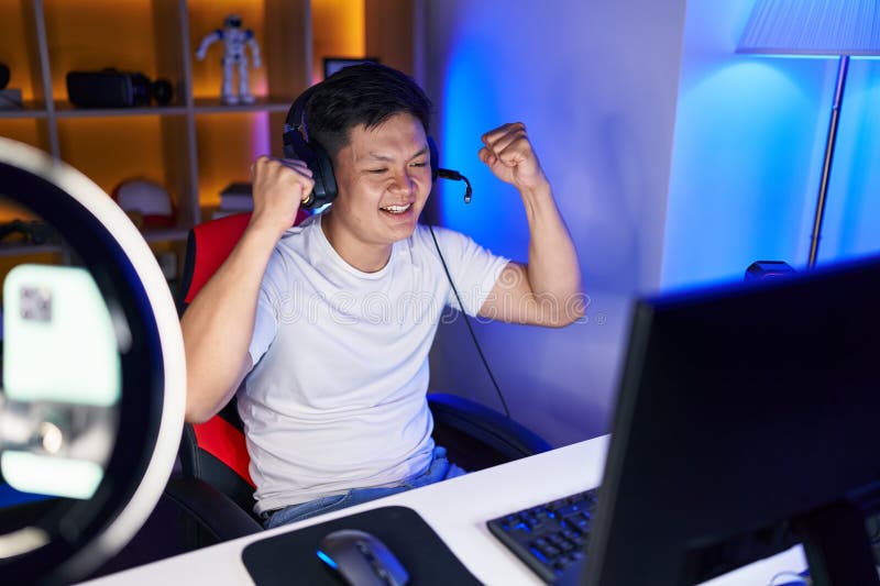 Young Chinese Man Streamer Playing Video Game with Winner Expression at ...