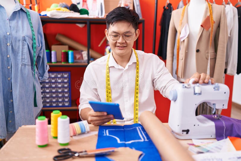 Young Chinese Man Tailor Smiling Confident Using Touchpad at Atelier ...