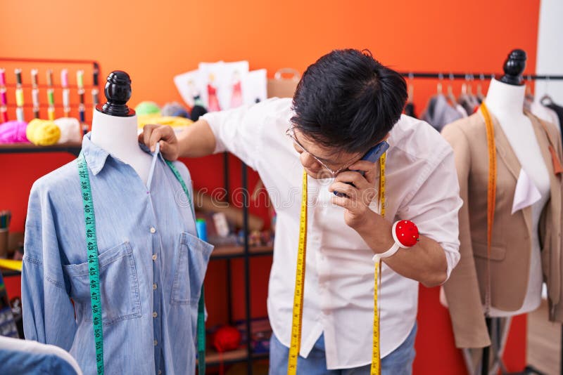 Young Chinese Man Tailor Talking on Smartphone Standing by Manikin at ...