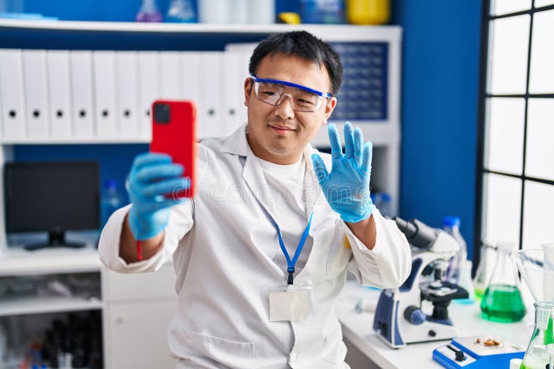 Young Chinese Man Wearing Scientist Uniform Having Video Call at ...