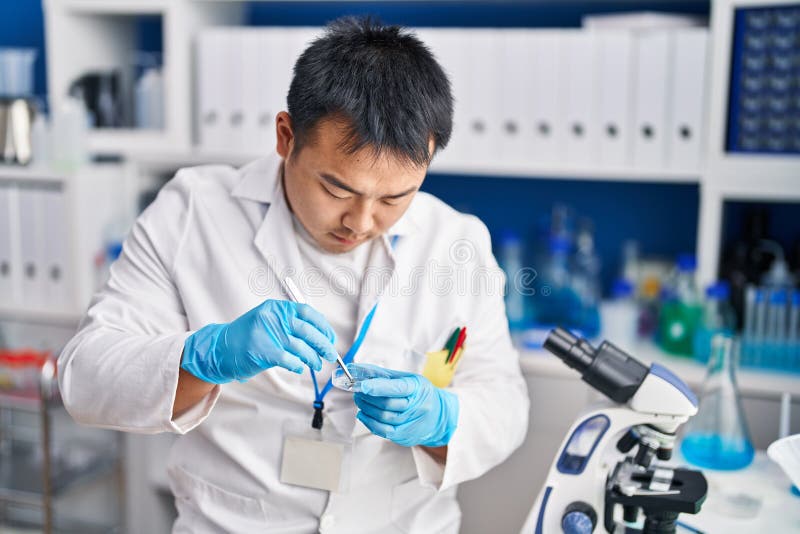 Young Chinese Man Wearing Scientist Uniform Working at Laboratory Stock ...