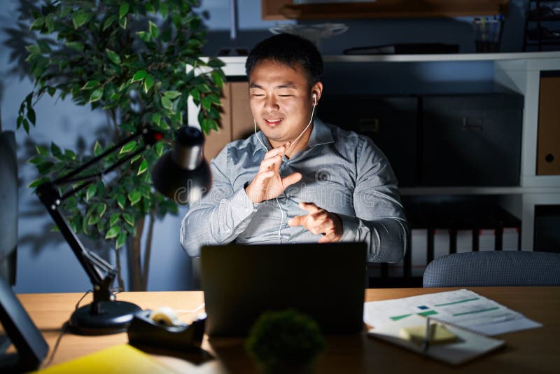 Young Chinese Man Working Using Computer Laptop at Night Disgusted ...