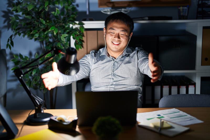 Young Chinese Man Working Using Computer Laptop at Night Looking at the ...