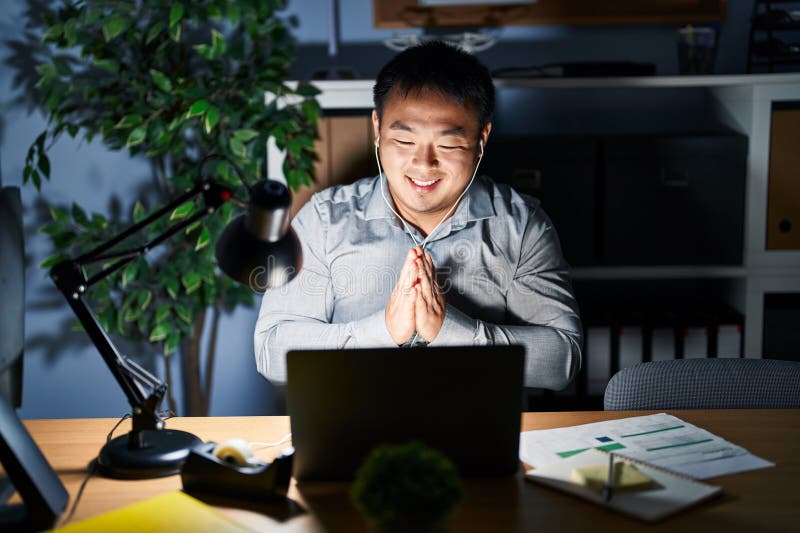Young Chinese Man Working Using Computer Laptop at Night Praying with ...