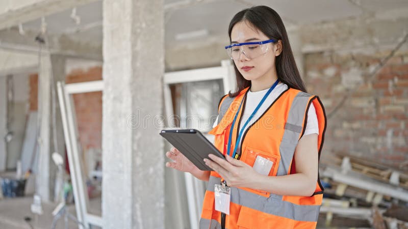 Young Chinese Woman Builder Using Touchpad at Construction Site Stock ...