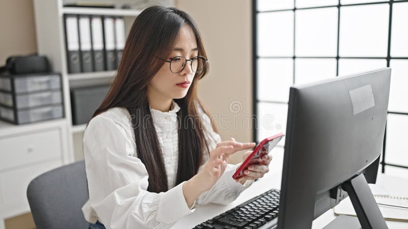 Young Chinese Woman Business Worker Using Computer and Smartphone at ...