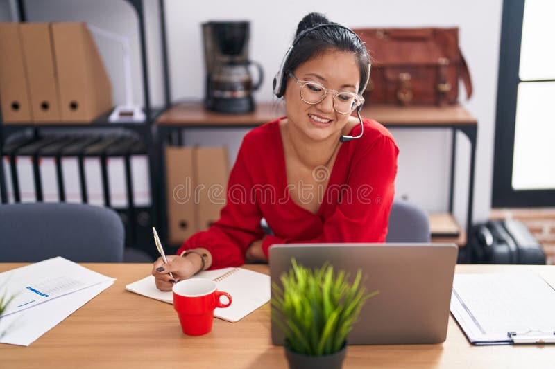 Young Chinese Woman Call Center Agent Writing on Notebook Working at ...