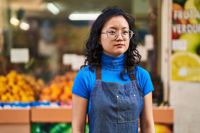 Young Chinese Woman Employee Standing with Serious Expression at Fruit ...