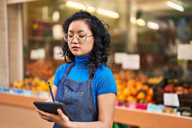 Young Chinese Woman Employee Using Touchpad at Fruit Store Stock Image ...