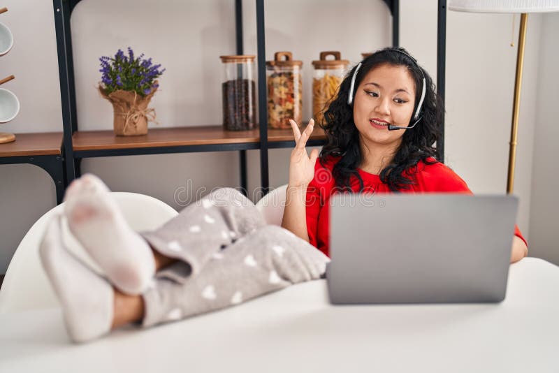 Young Chinese Woman Operator Having Video Call at Home Stock Photo ...