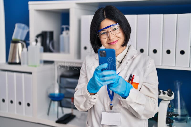 Young Chinese Woman Scientist Using Smartphone Working at Laboratory ...