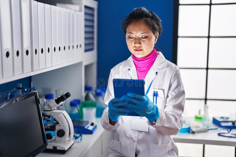 Young Chinese Woman Scientist Using Touchpad at Laboratory Stock Image ...