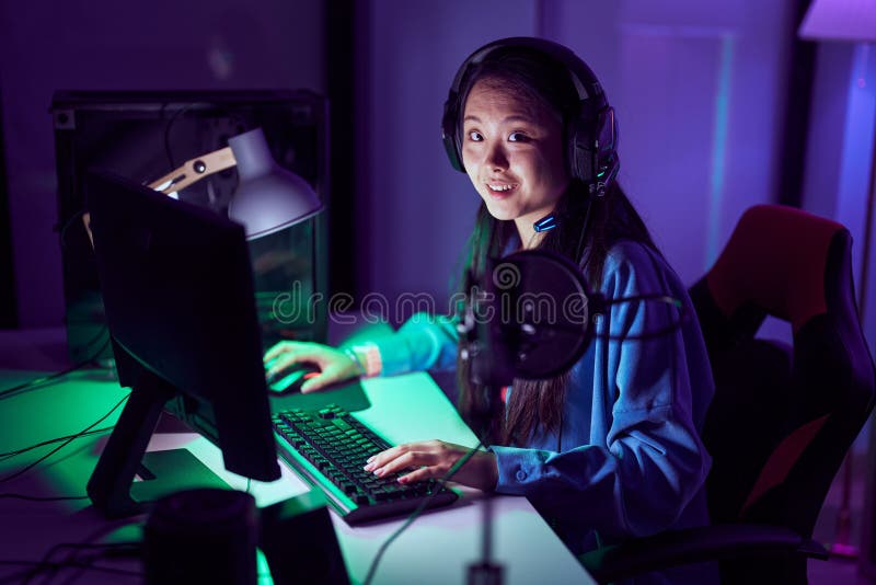 Young Chinese Woman Streamer Playing Video Game Using Computer at ...