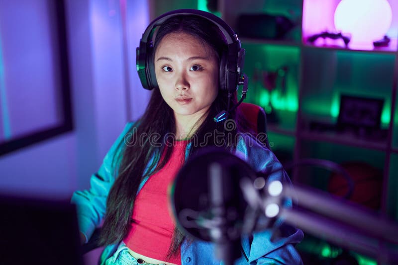 Young Chinese Woman Streamer Playing Video Game Using Computer at ...