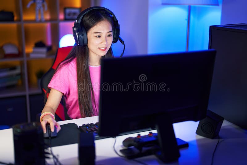 Young Chinese Woman Streamer Playing Video Game Using Computer at ...